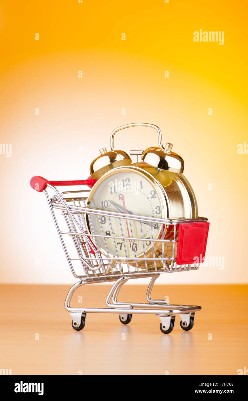 Buying time concept with clock and shopping cart Stock Photo - Alamy