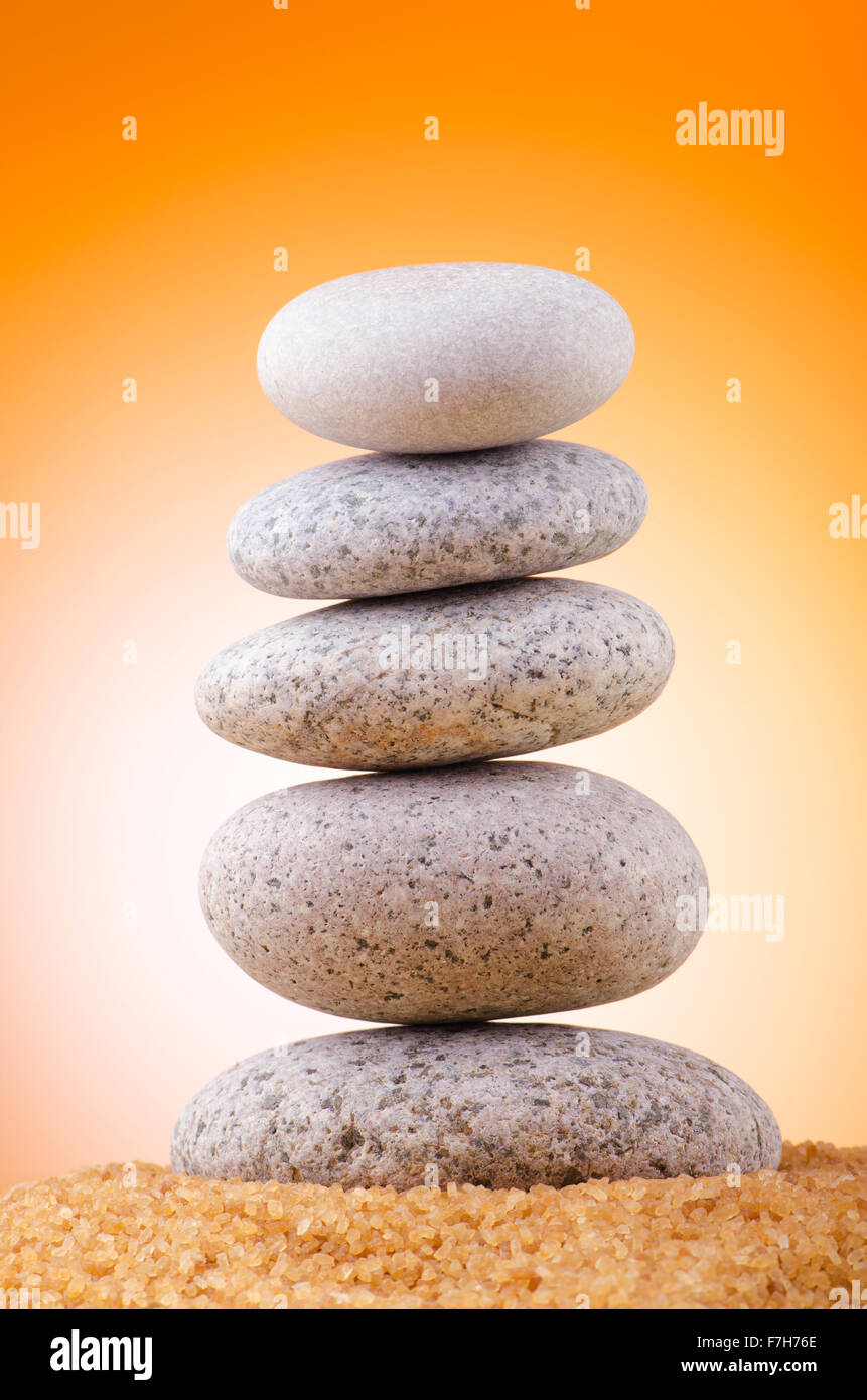 Balanced pebbles with colour background Stock Photo - Alamy