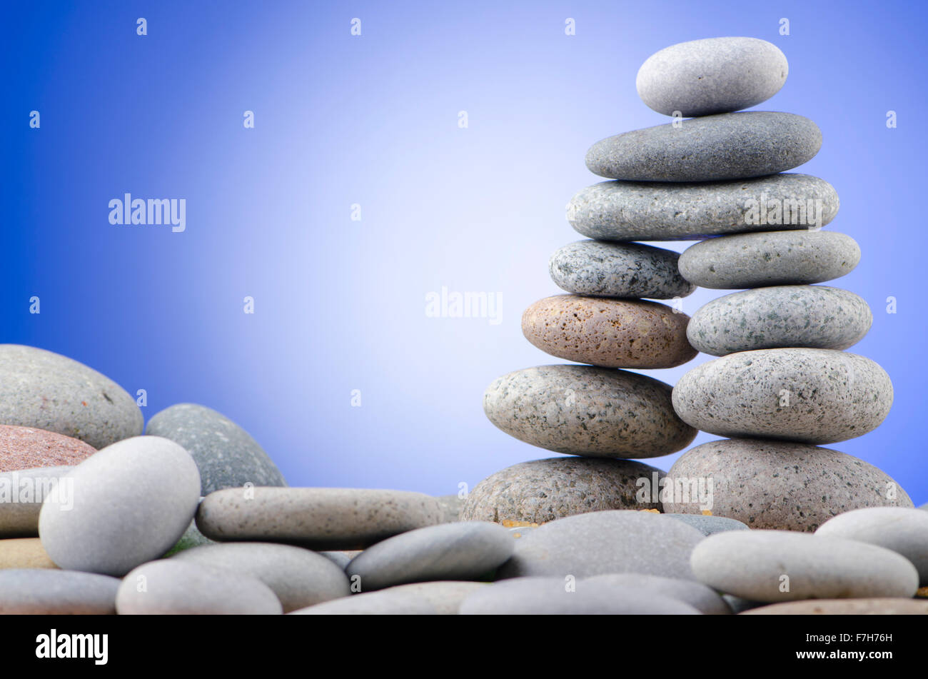 Balanced pebbles with colour background Stock Photo - Alamy