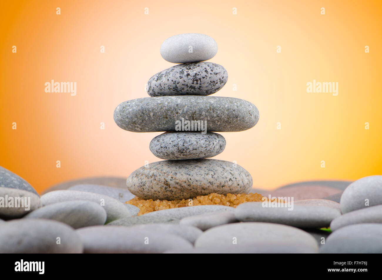 Balanced pebbles with colour background Stock Photo - Alamy