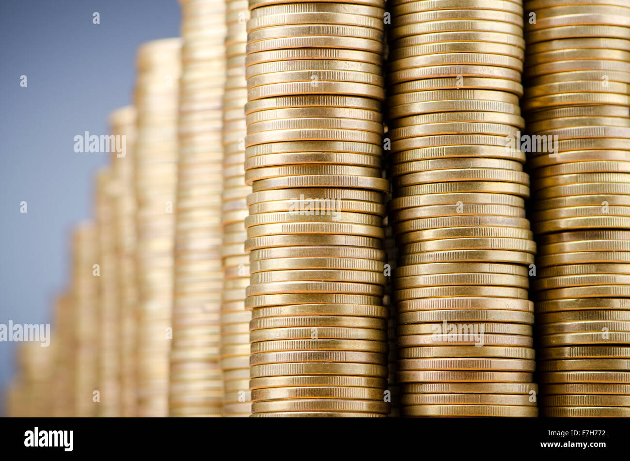 Golden coins in high stacks Stock Photo - Alamy
