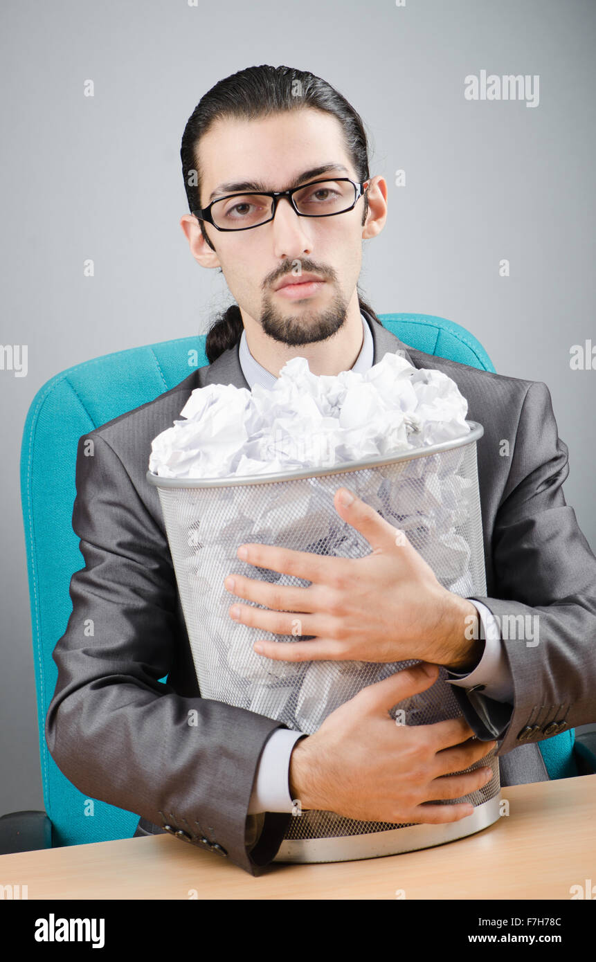 Man with lots of wasted paper Stock Photo - Alamy