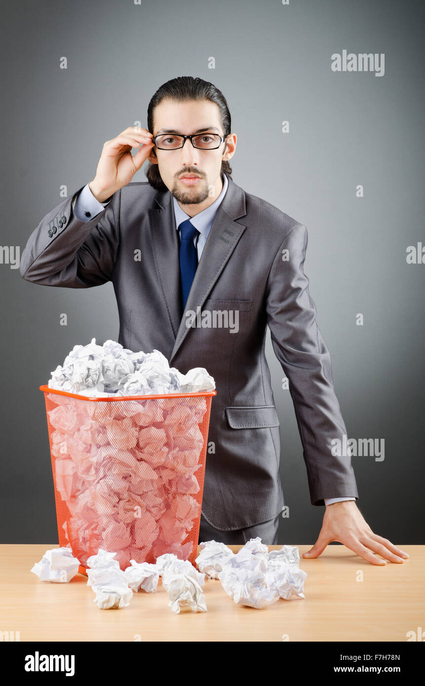Man with lots of wasted paper Stock Photo - Alamy