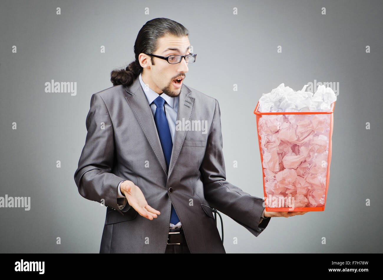 Man with lots of wasted paper Stock Photo - Alamy