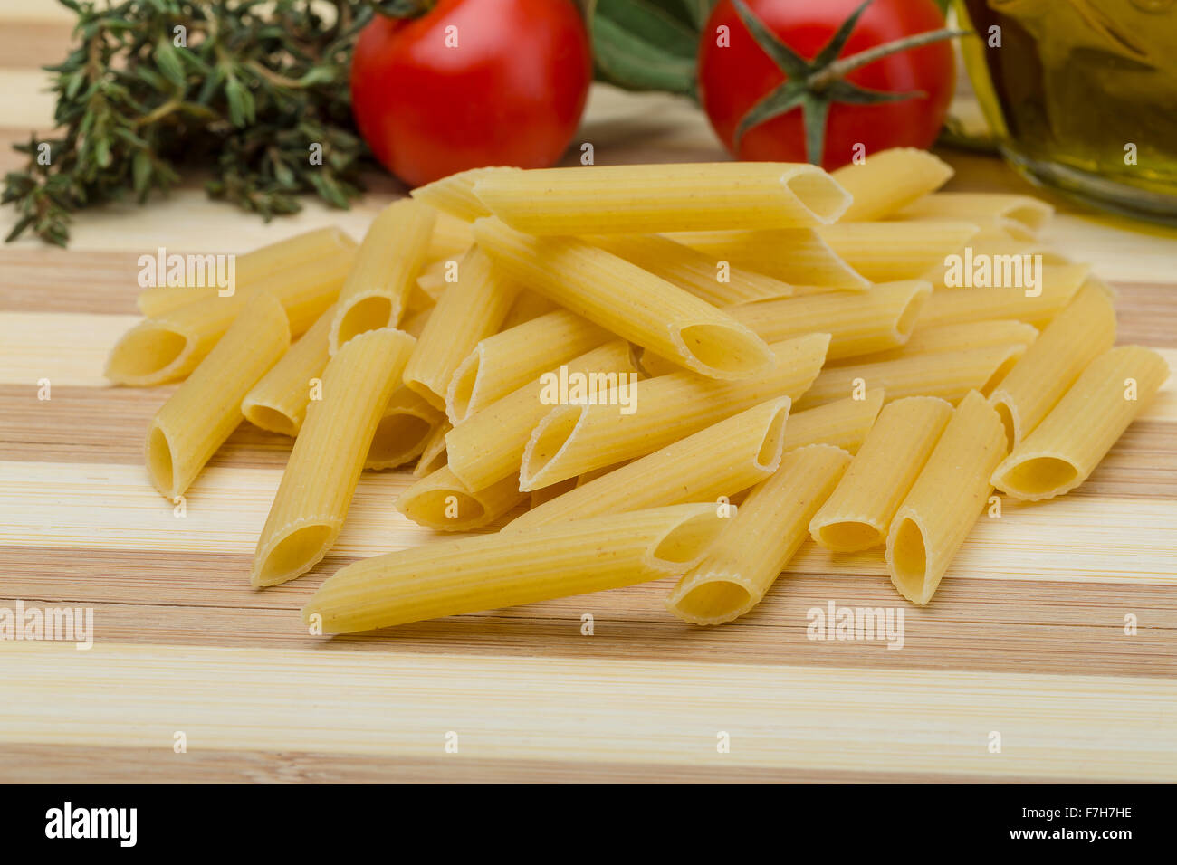 Raw penne pasta on the wood background Stock Photo - Alamy