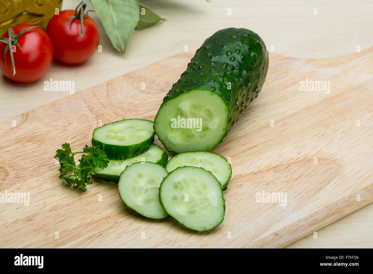 Green Sliced cucumber on the wood background Stock Photo - Alamy
