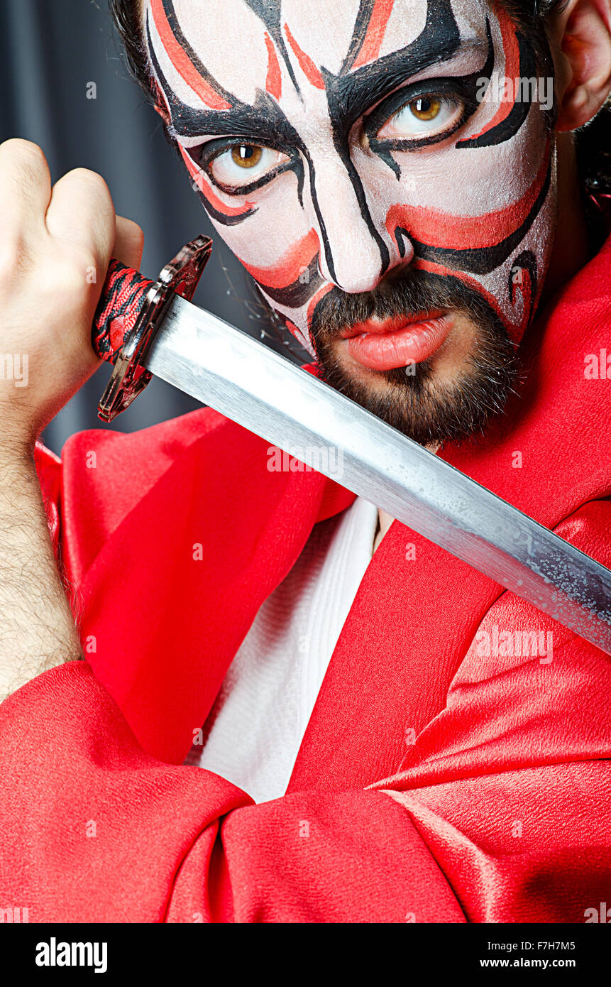 Man with face mask and sword Stock Photo - Alamy