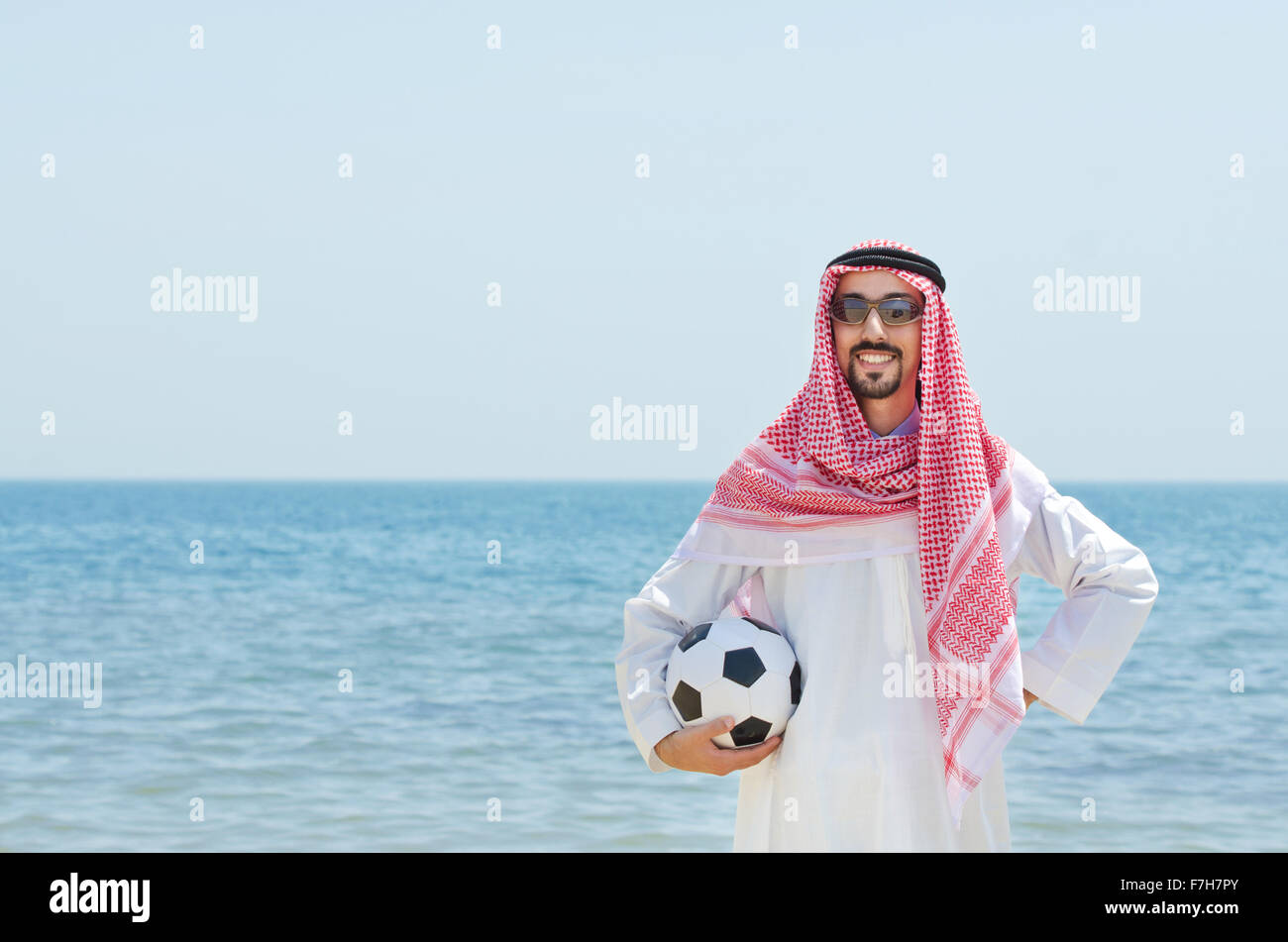 Arab with footbal at seaside Stock Photo - Alamy