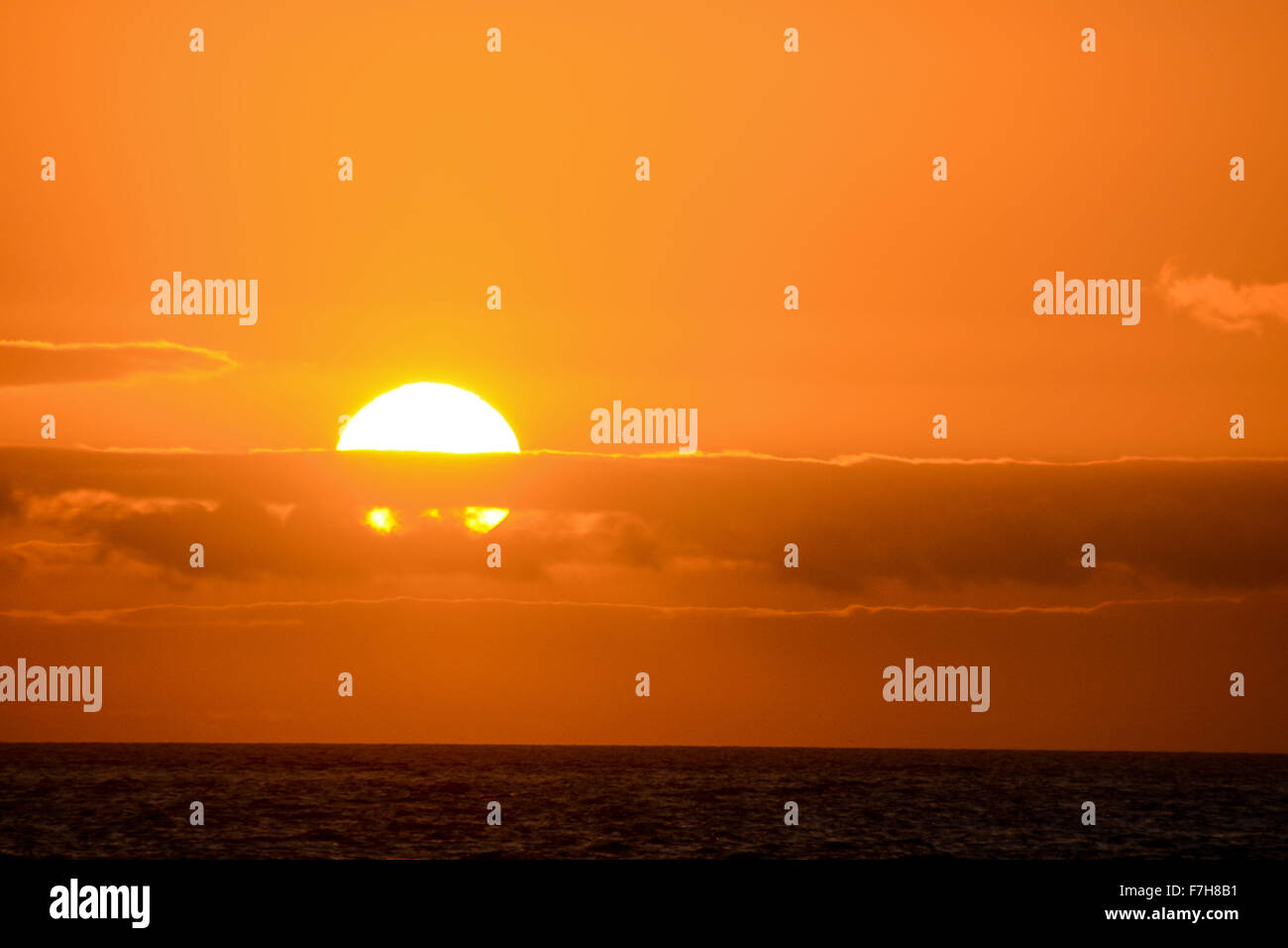 The Sun Setting in the Sea Stock Photo - Alamy