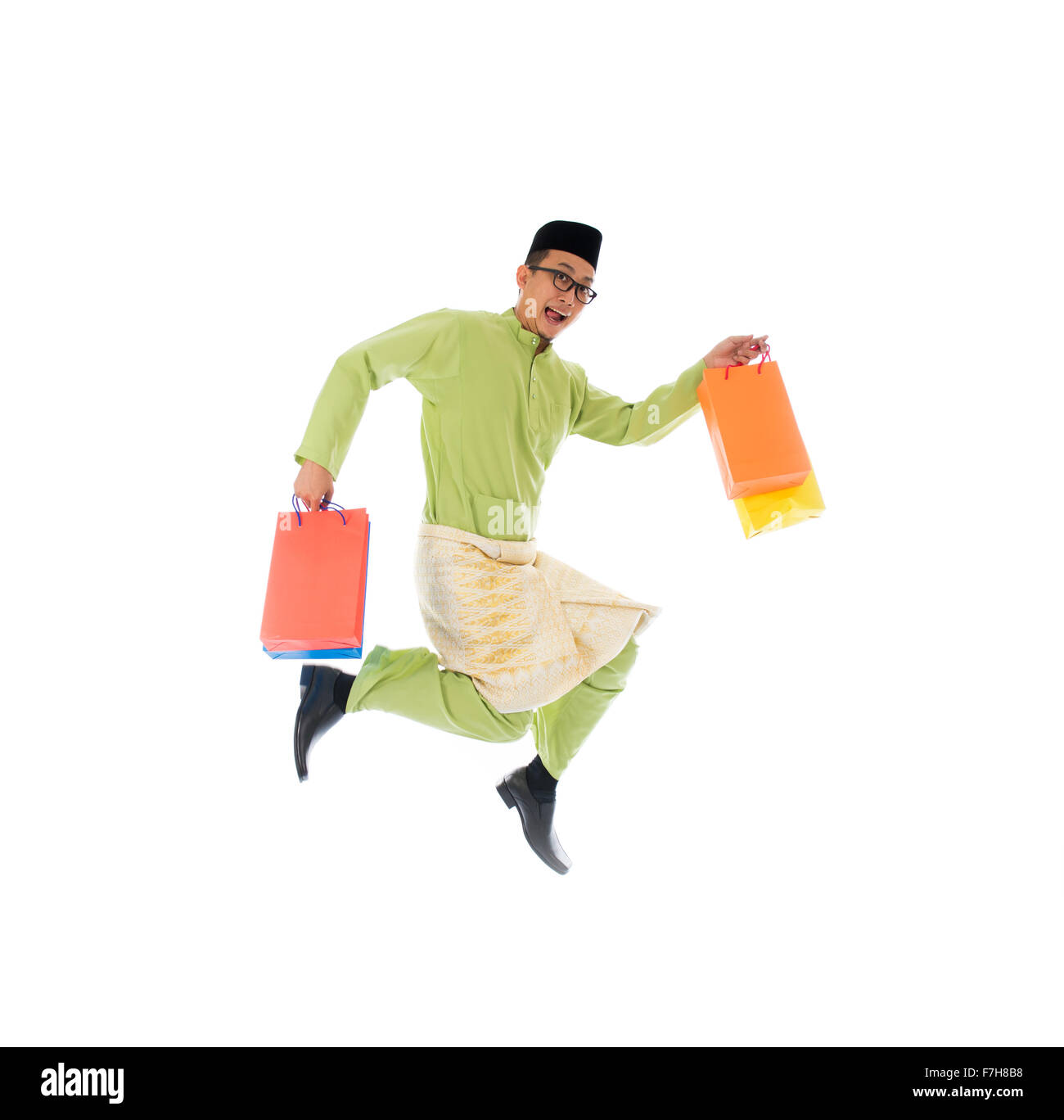 Traditional Malay male shopping and jumping in joy during hari raya ...