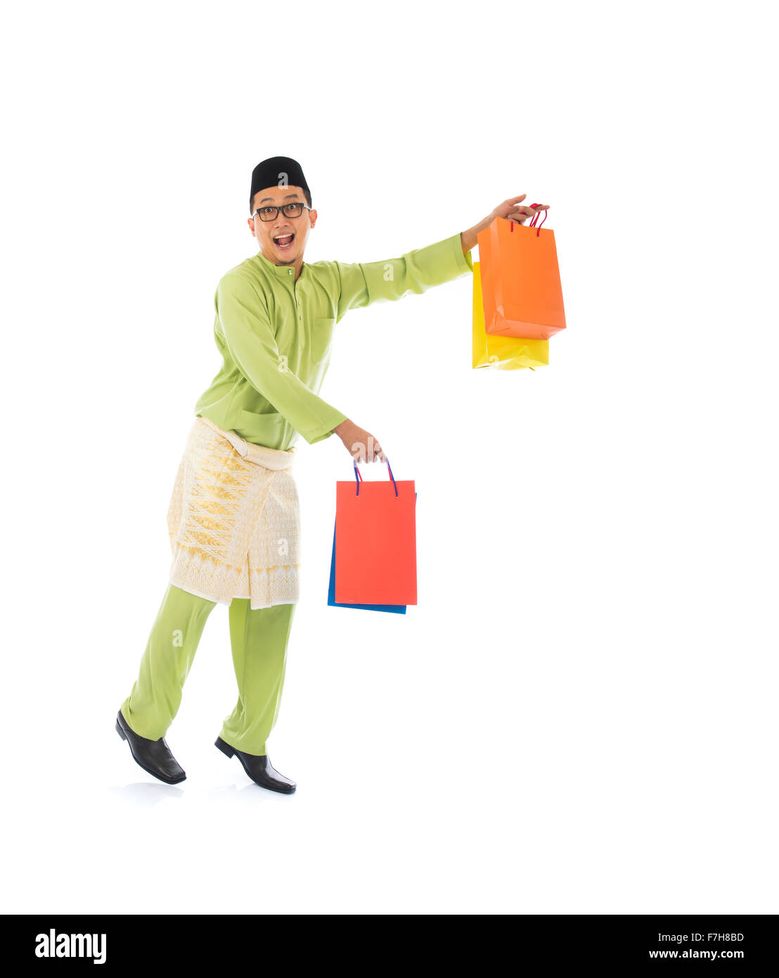 Traditional Malay male shopping and jumping in joy during hari raya ...