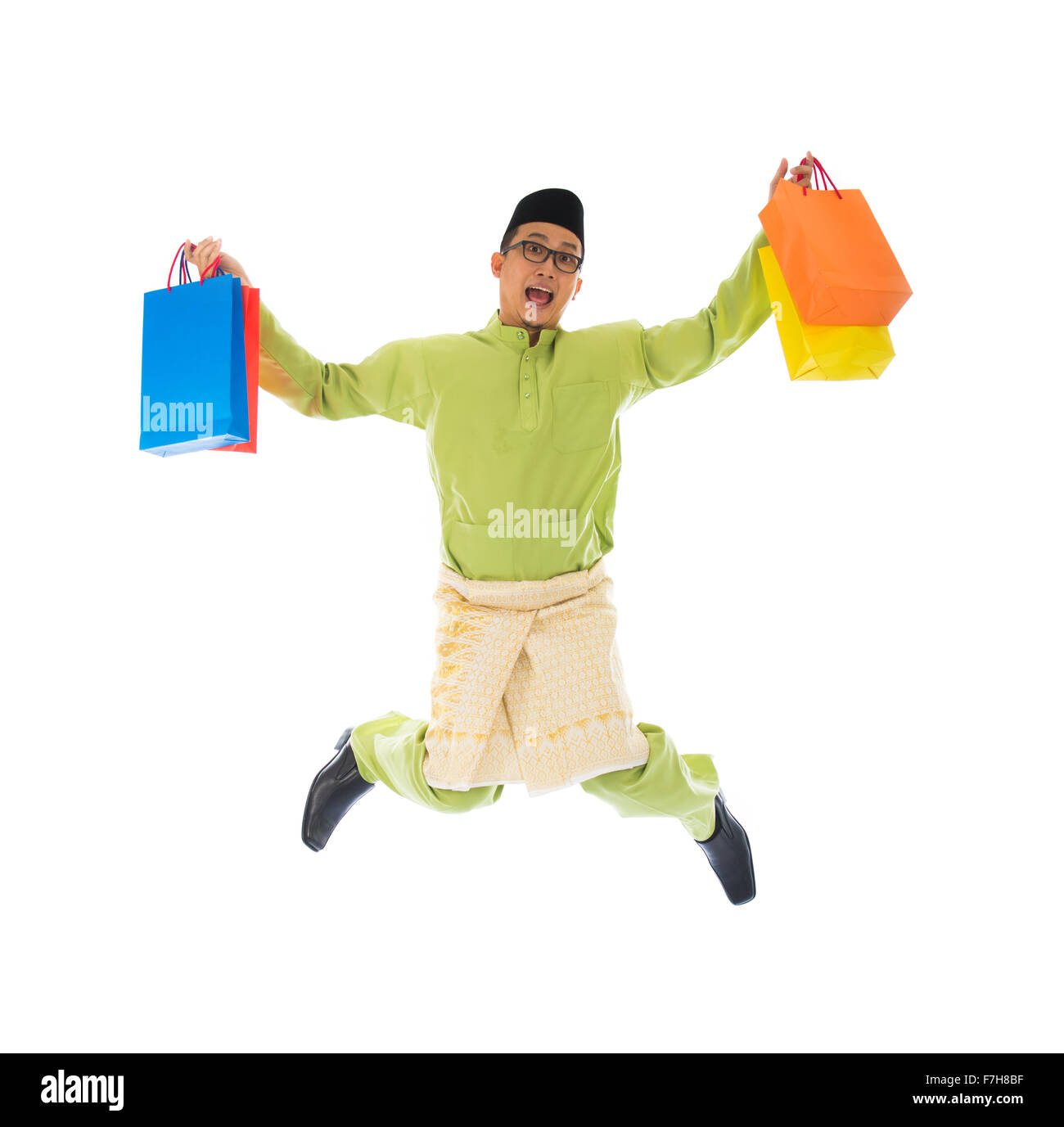 Traditional Malay male shopping and jumping in joy during hari raya ...