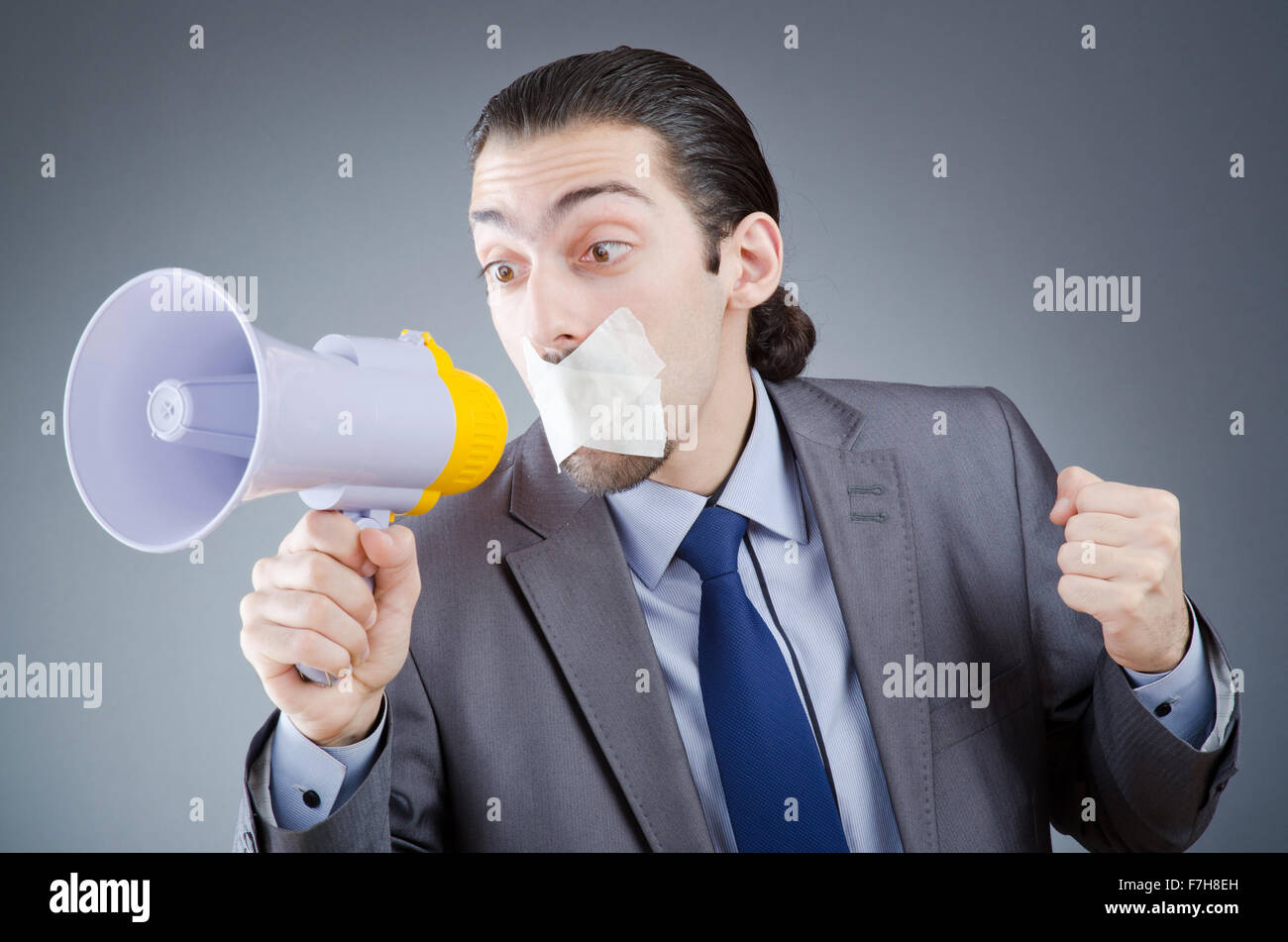 Businessman shouting via loudspeaker Stock Photo - Alamy