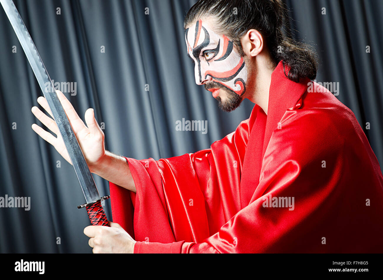 Man with face mask and sword Stock Photo - Alamy