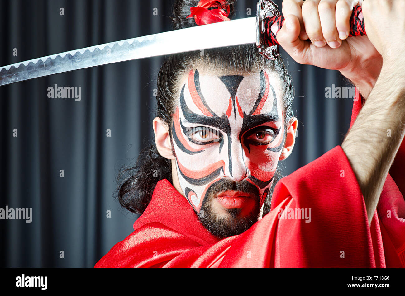 Man with face mask and sword Stock Photo - Alamy