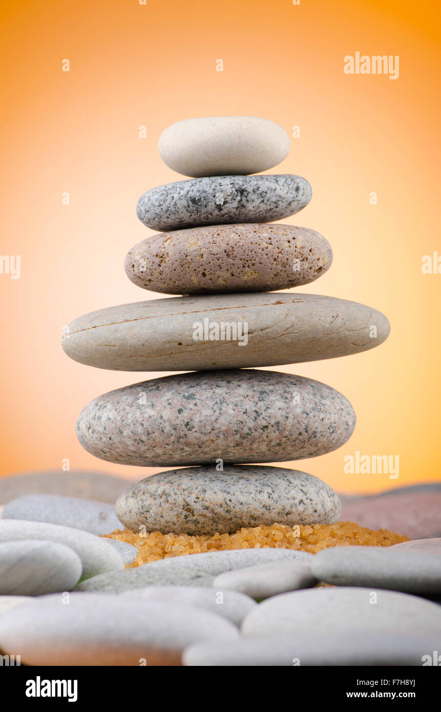 Balanced pebbles with colour background Stock Photo - Alamy