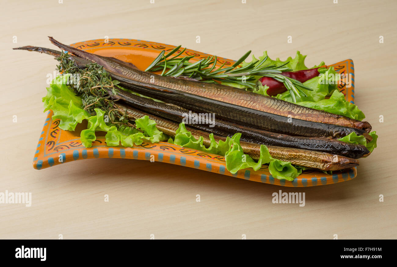 Smoked Lamprey - seafood delicacy with salad and herbs Stock Photo - Alamy