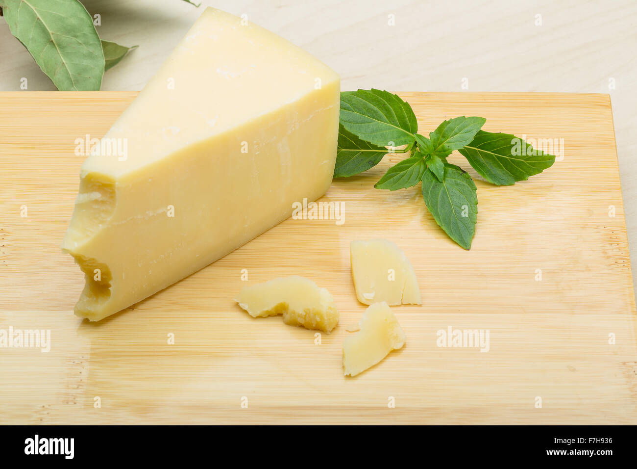 Parmesan cheese with basil leaves on the wood background Stock Photo ...