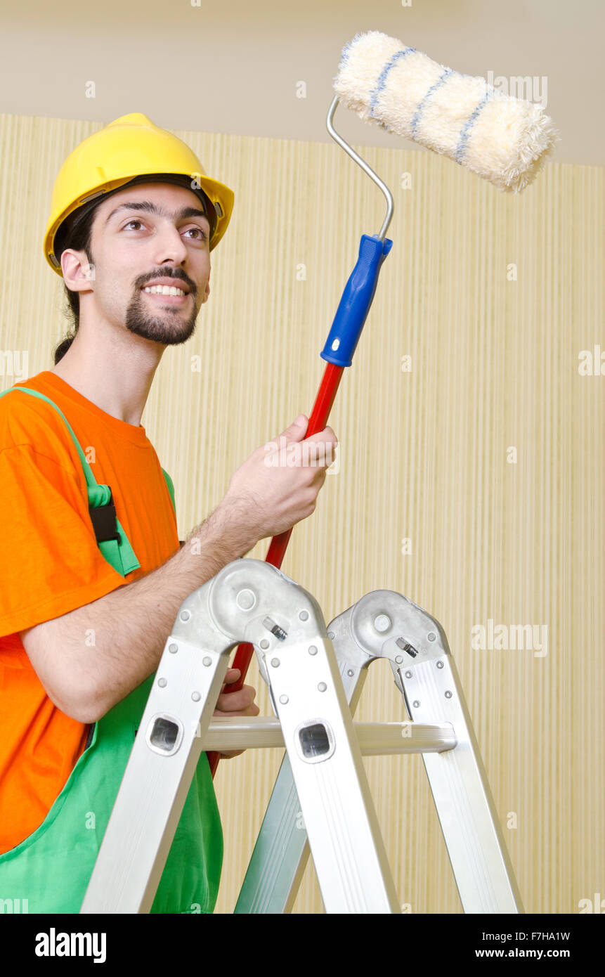 Painter worker during painting job Stock Photo - Alamy