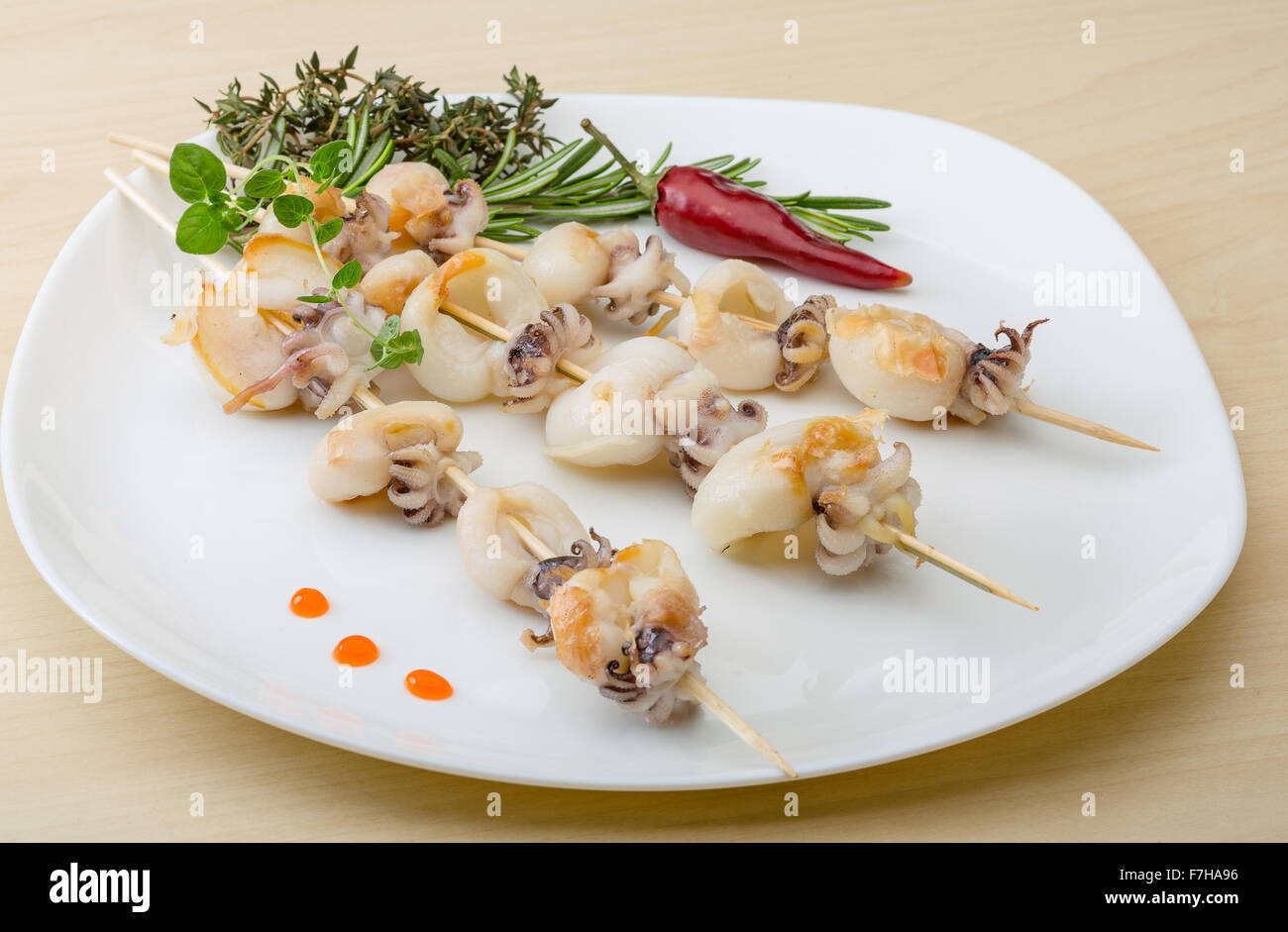 Grilled cuttlefish bbq with rosemary and pepper Stock Photo - Alamy