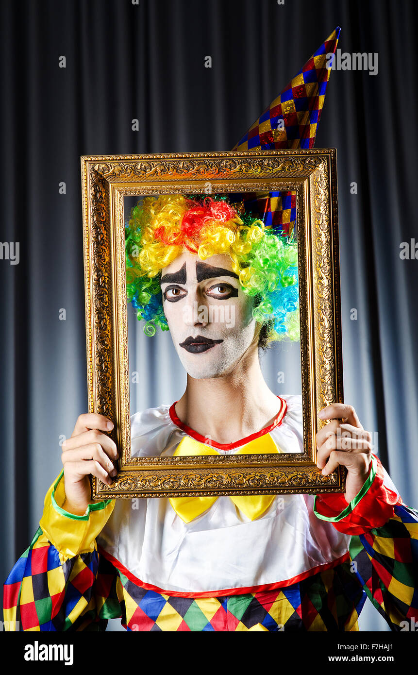 Clown with picture frames in studio Stock Photo - Alamy