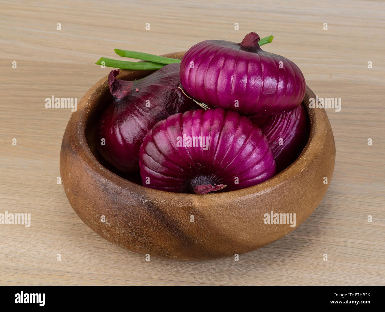 Violet onion in the basket with green Stock Photo - Alamy