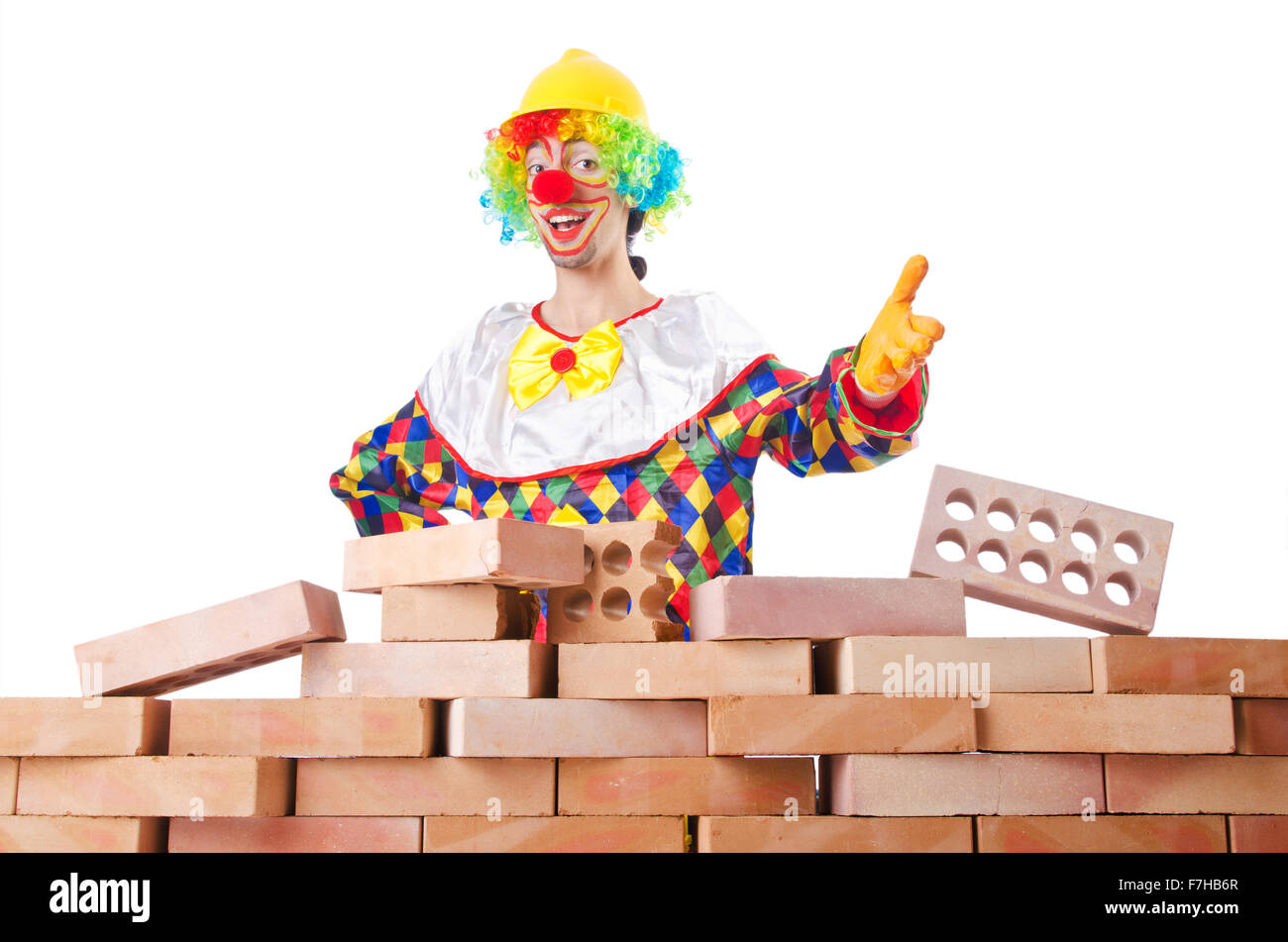 Bad construction concept with clown laying bricks Stock Photo - Alamy