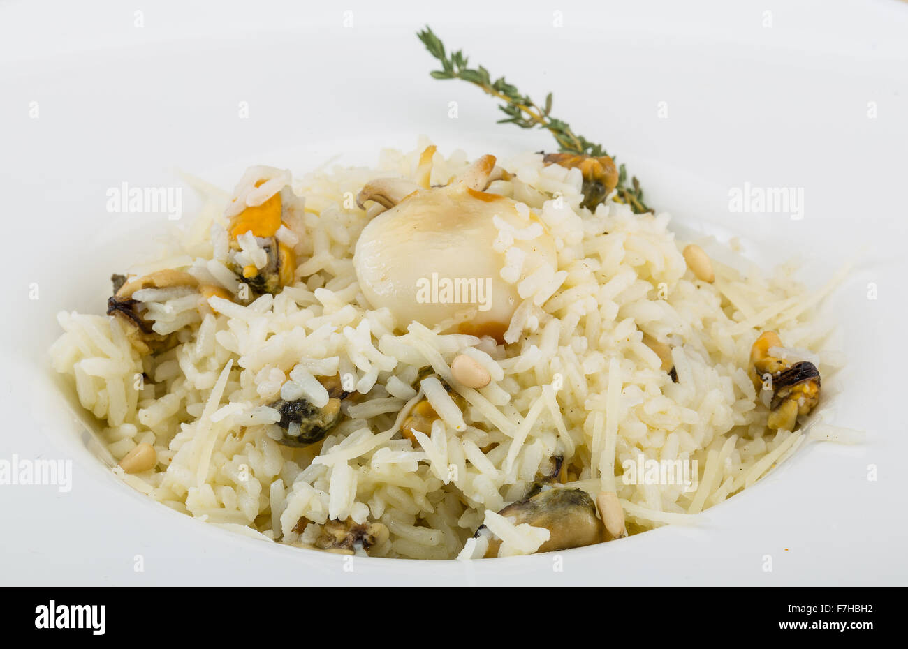 Risotto with mussels and cuttlefish served fresh thyme Stock Photo - Alamy