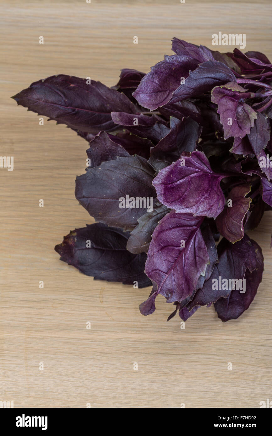 Violet basil leaves on the wood background Stock Photo - Alamy