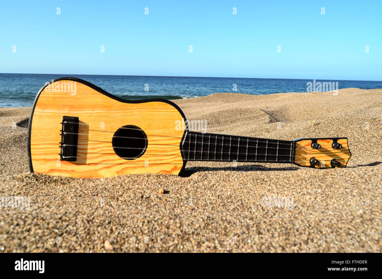 Guitar on the Sand Beach Stock Photo - Alamy