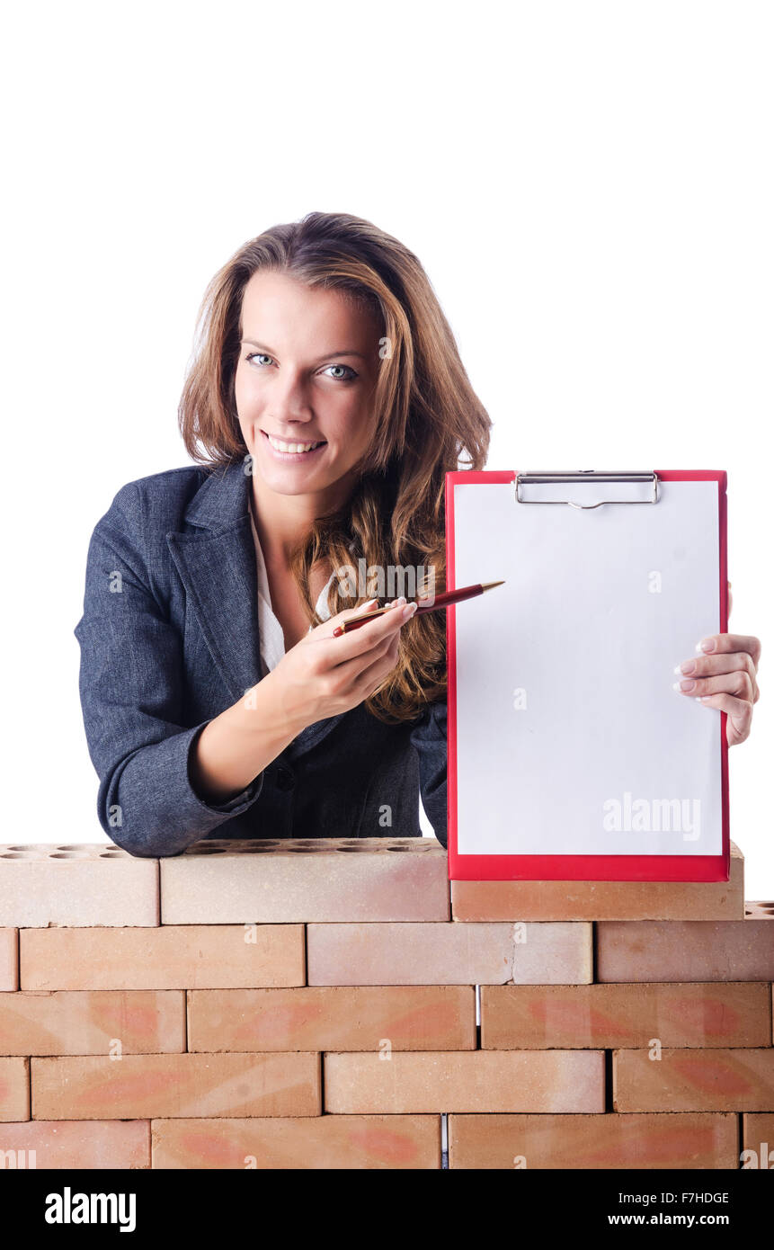 Woman builder and brick wall Stock Photo - Alamy