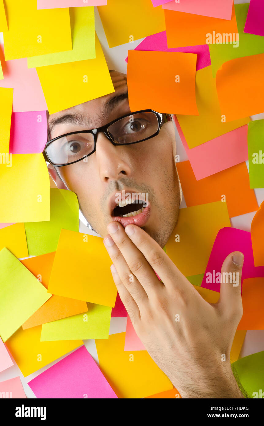 Man's face through paper and reminders Stock Photo - Alamy