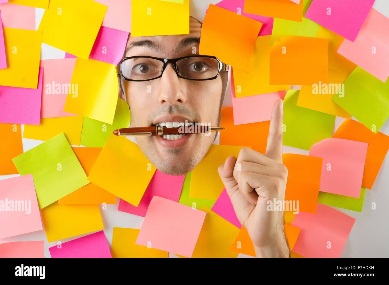 Man's face through paper and reminders Stock Photo - Alamy