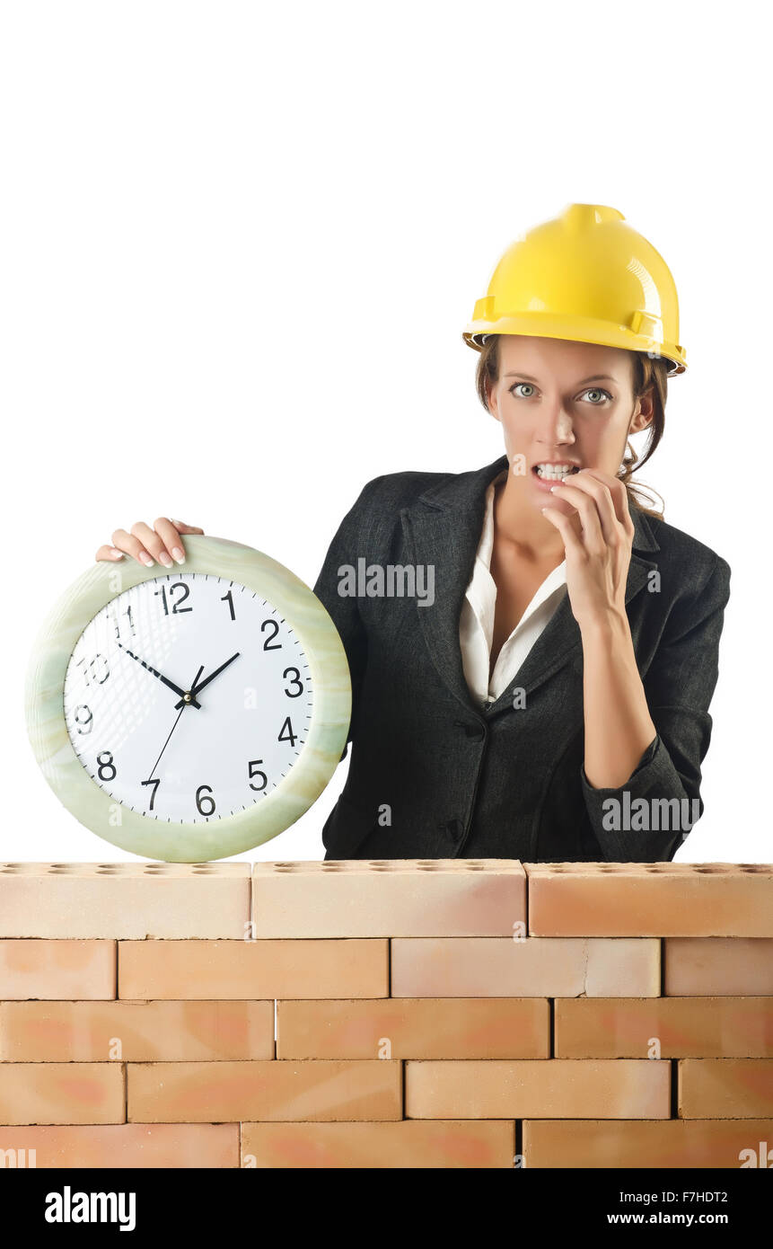 Female builder and clock on white Stock Photo - Alamy