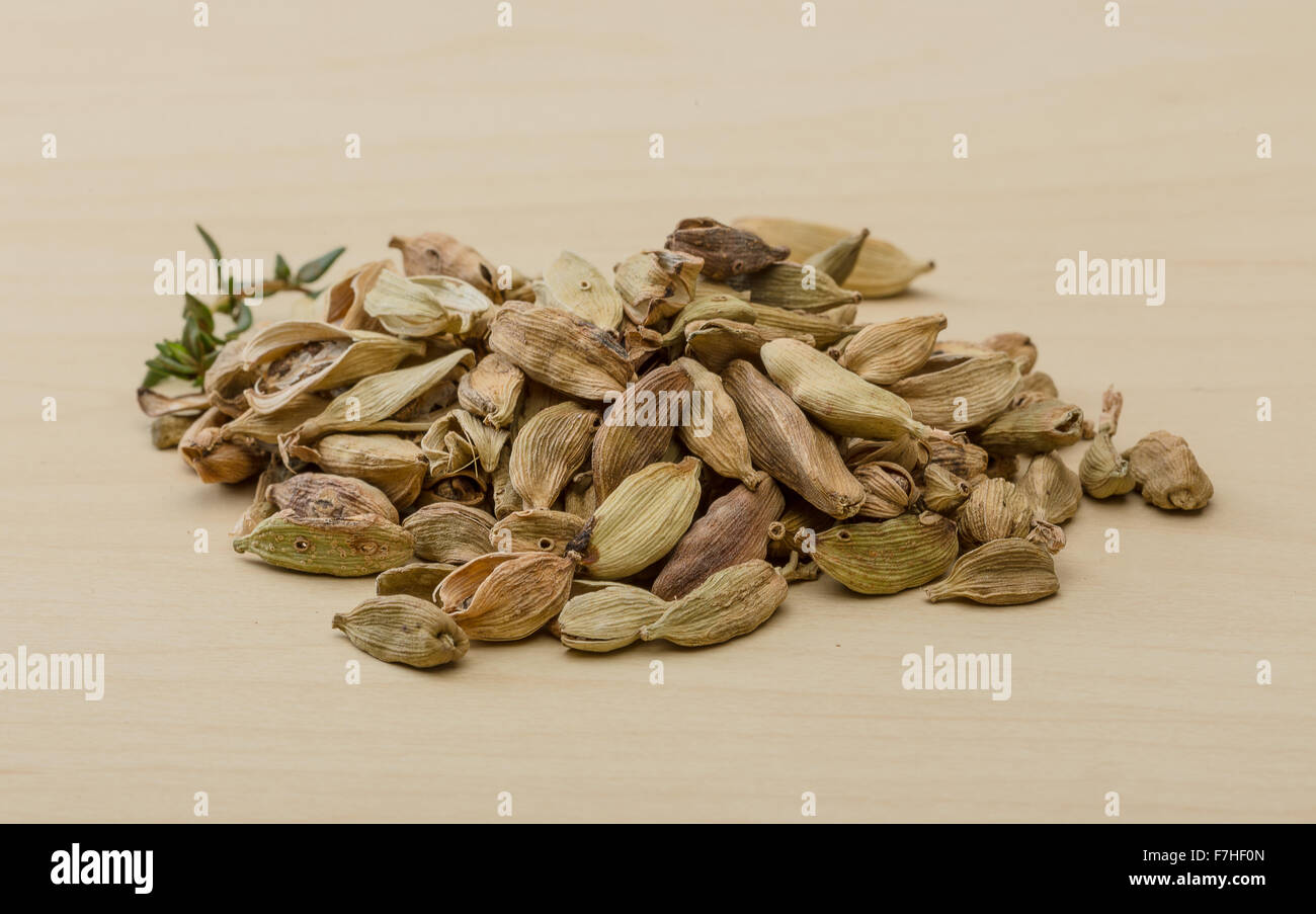 Dry Cardamom heap on the wood background Stock Photo - Alamy