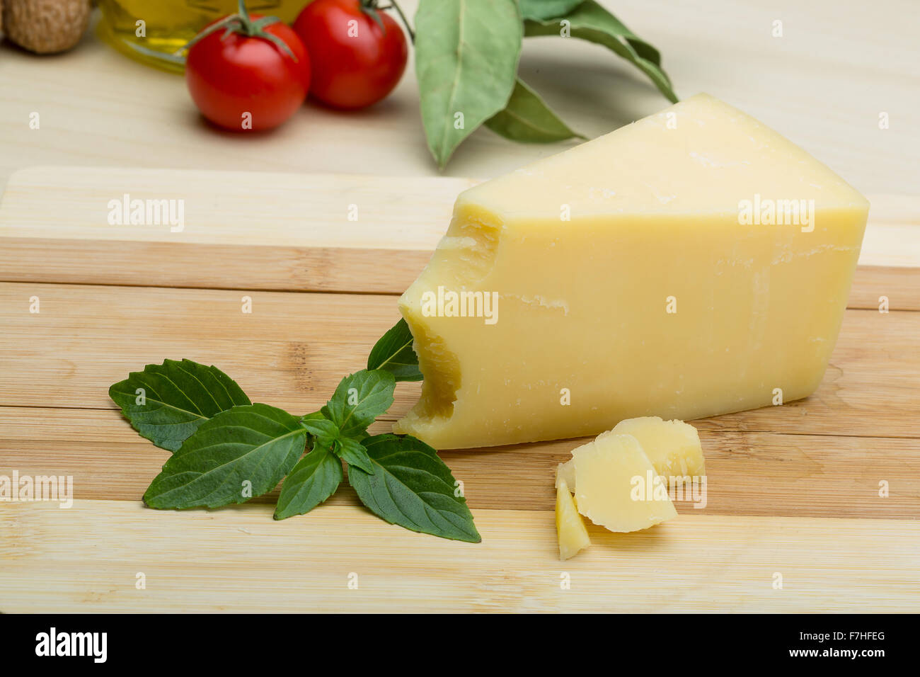 Parmesan cheese with basil leaves on the wood background Stock Photo ...