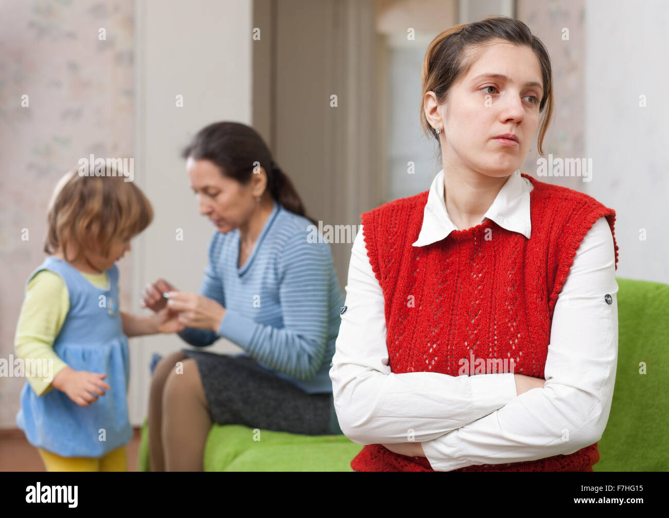 Conflict between generations. Sad young woman against mother and ...