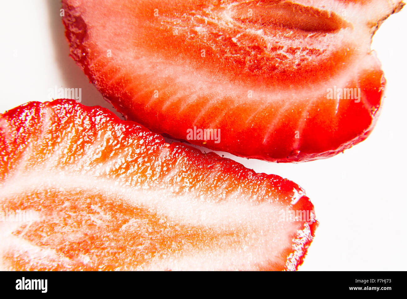 An open strawberry photographed close-up on white background ...