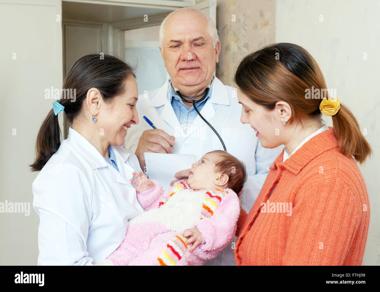 pediatrician doctors give the healthy baby to happy mother Stock Photo ...