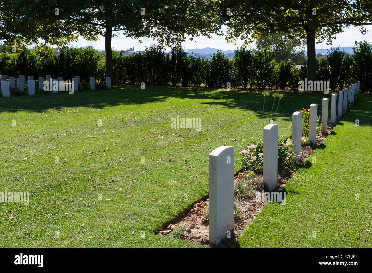 Ranks of well tendered and planted gravestones in a quiet garden. War ...