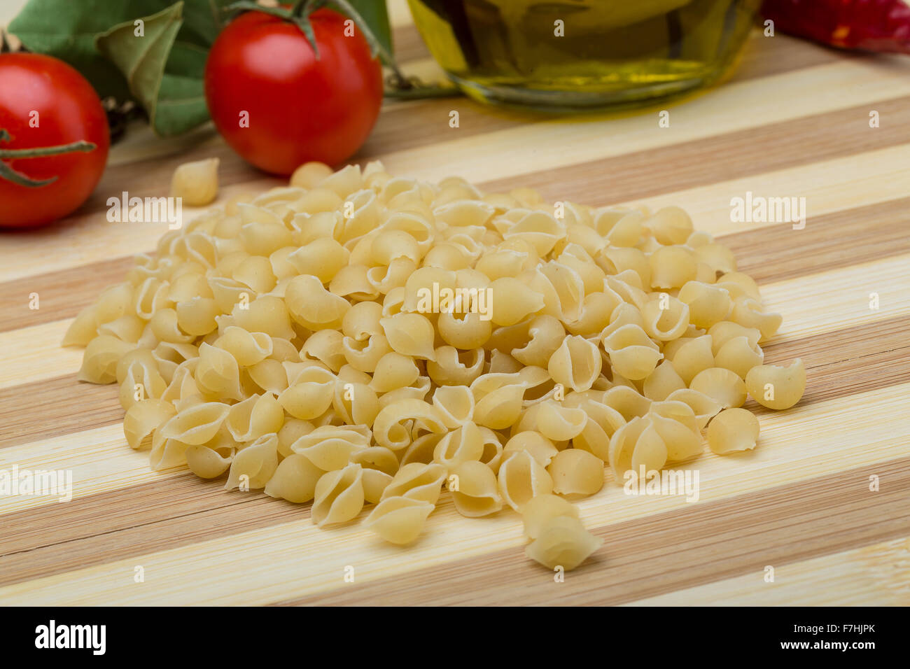 Raw Shell pasta on the wood background Stock Photo - Alamy