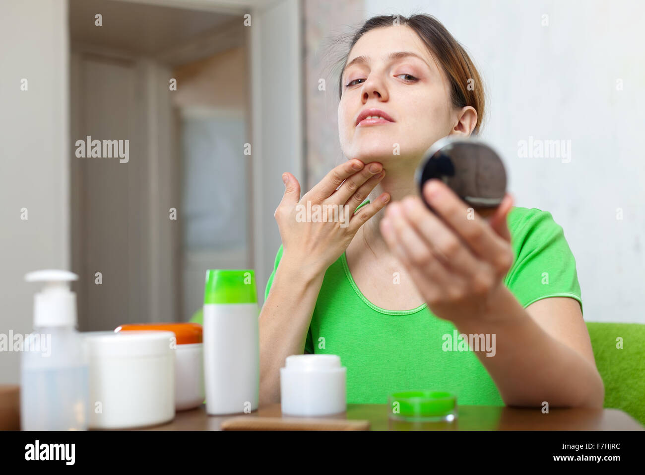 woman looks on her neck in mirror at home Stock Photo - Alamy