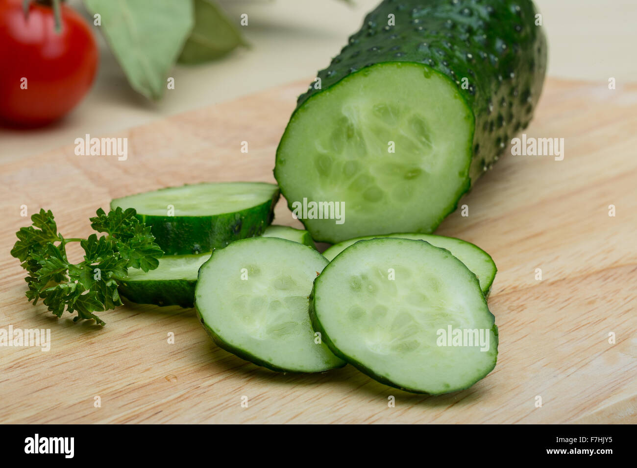 Green Sliced cucumber on the wood background Stock Photo - Alamy