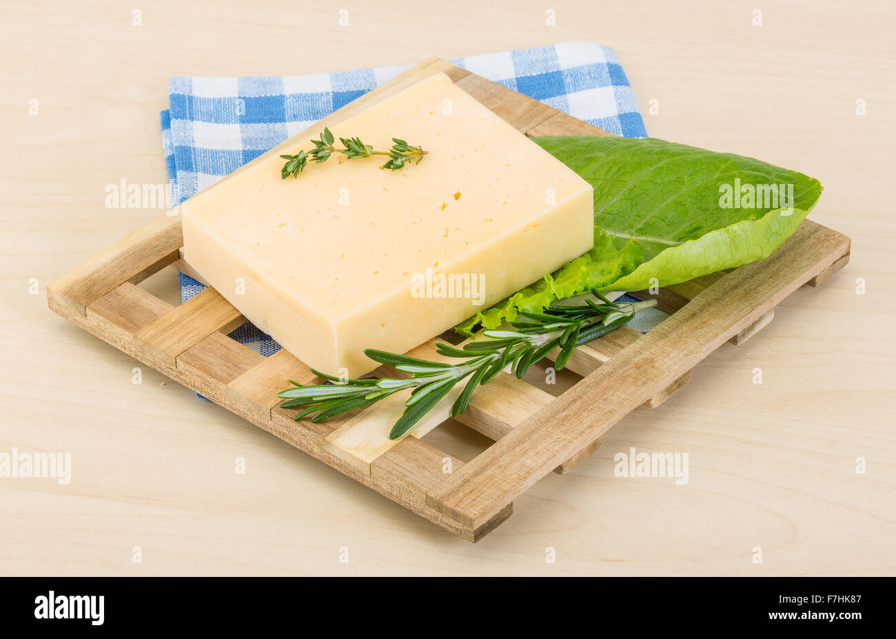 Yellow cheese brick with rosemary and thyme Stock Photo - Alamy