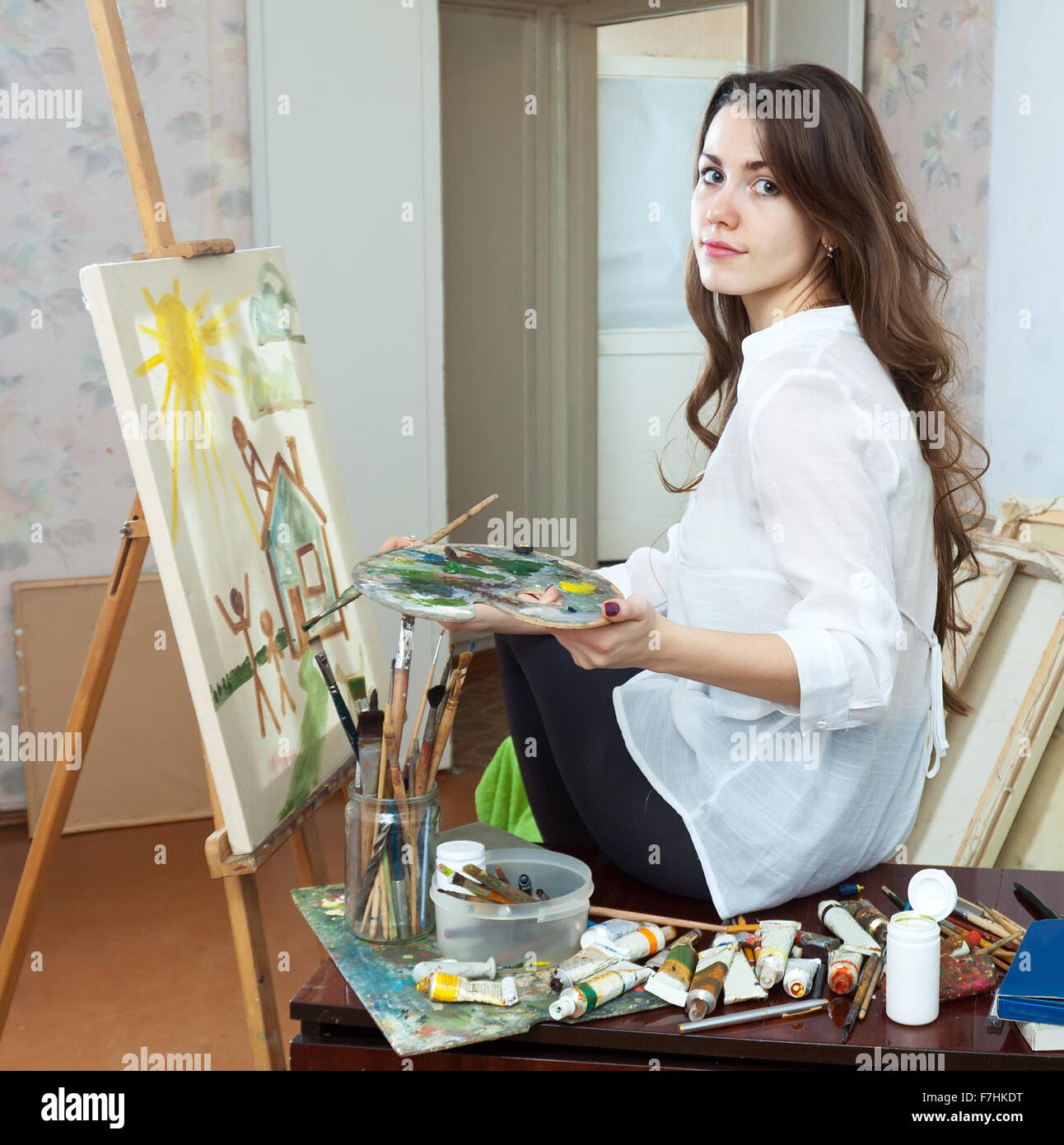 Female artist paints picture on canvas with oil paints in her stidio ... Female artist paints picture on canvas with oil paints in her stidio ...