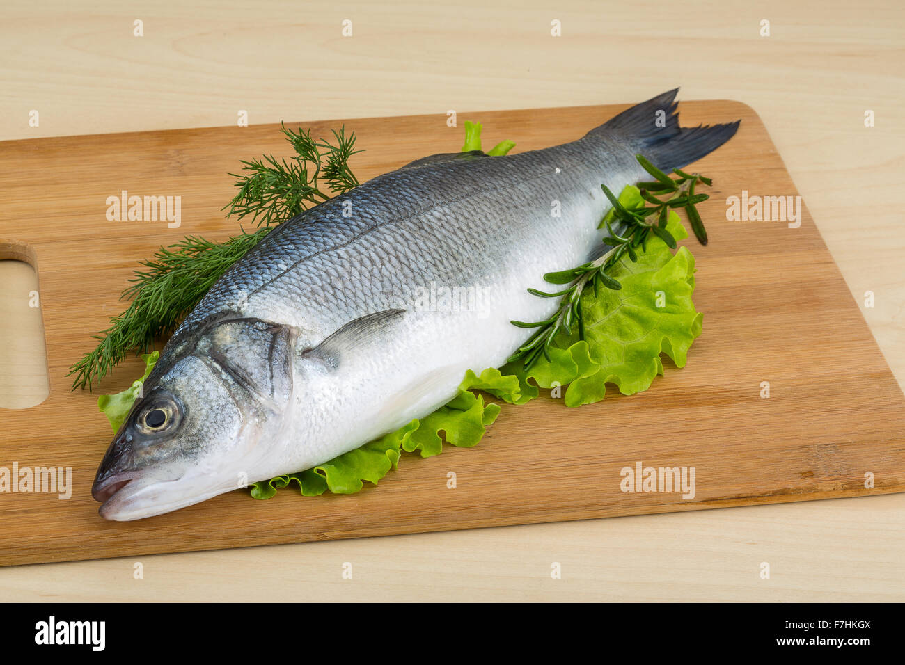 Raw seabass fish with rosemary and dill Stock Photo - Alamy