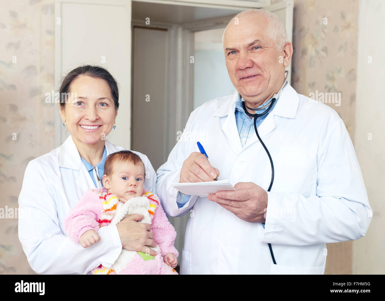 Portrait of friendly doctors with three months baby Stock Photo - Alamy