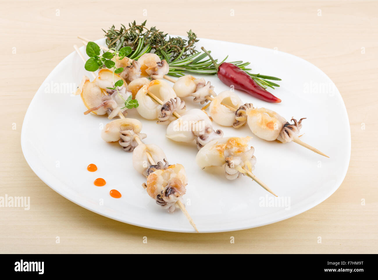 Grilled cuttlefish bbq with rosemary and pepper Stock Photo - Alamy