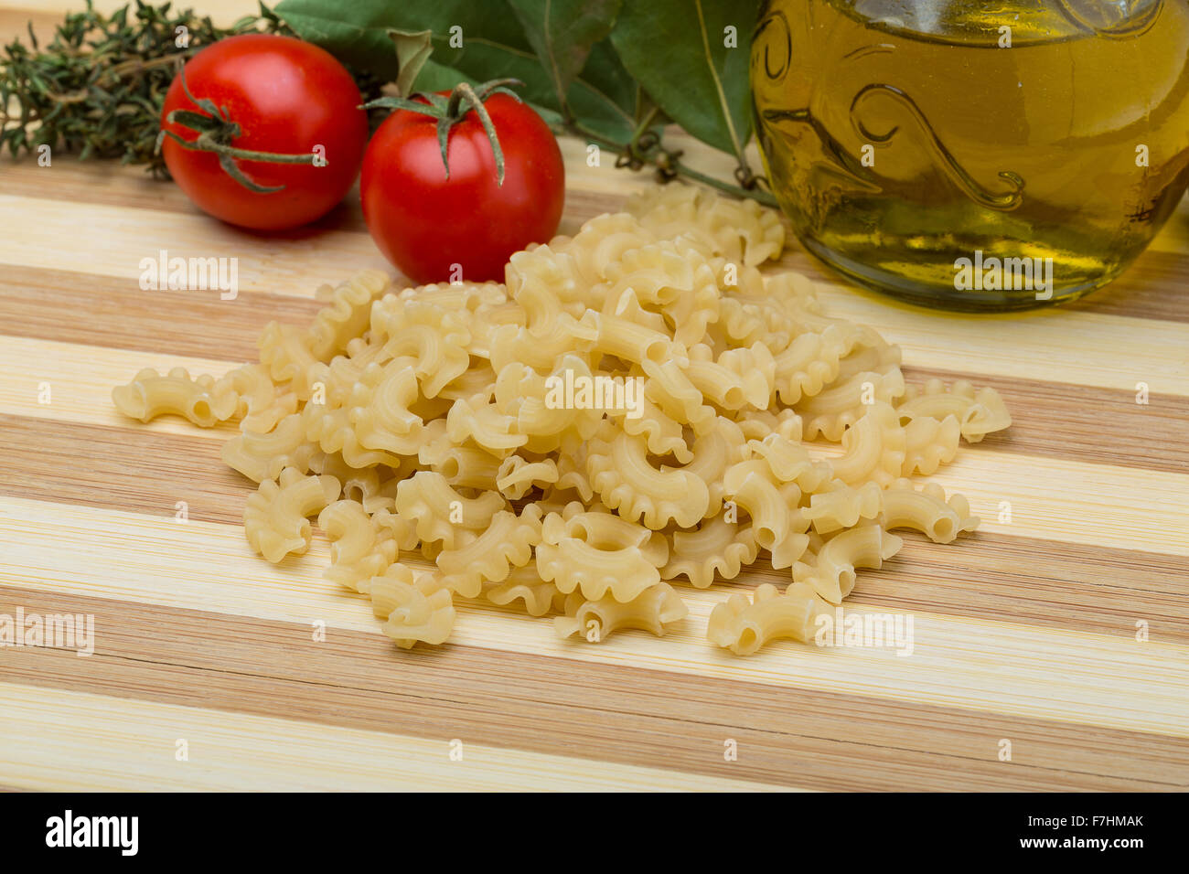 Raw Italian Pasta Creste di gallo on wood background Stock Photo - Alamy
