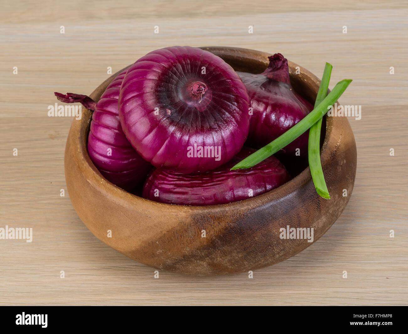 Violet onion in the basket with green Stock Photo - Alamy